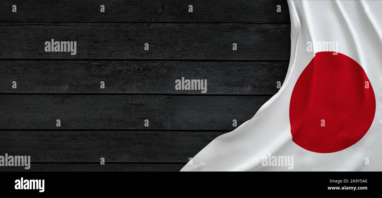 Flag of Japan, fabric on dark wood Stock Photo - Alamy
