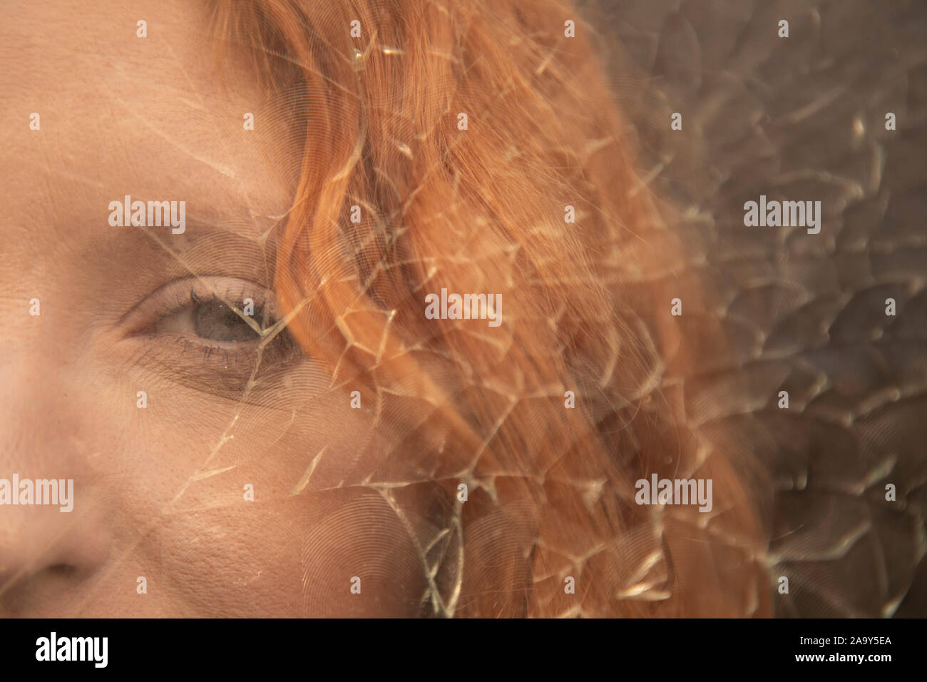 Womans eye looking through Broken shattered glass window Stock Photo ...