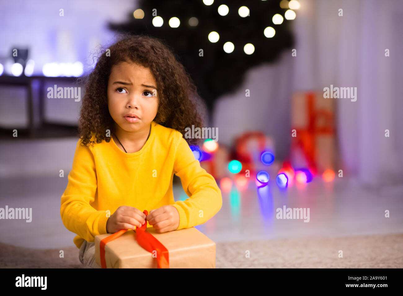 Sad little girl christmas tree hi-res stock photography and images - Alamy