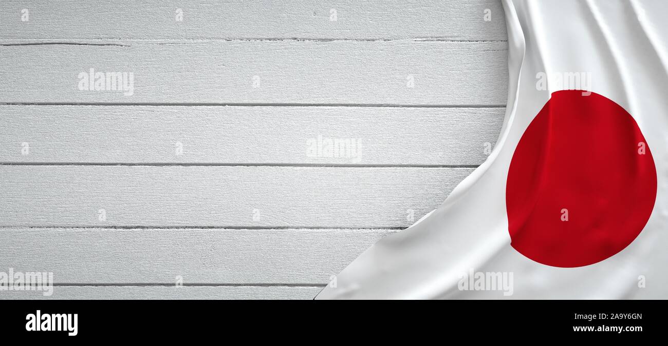 Japan flag, on top of white wood. Wrinkled fabric Stock Photo - Alamy
