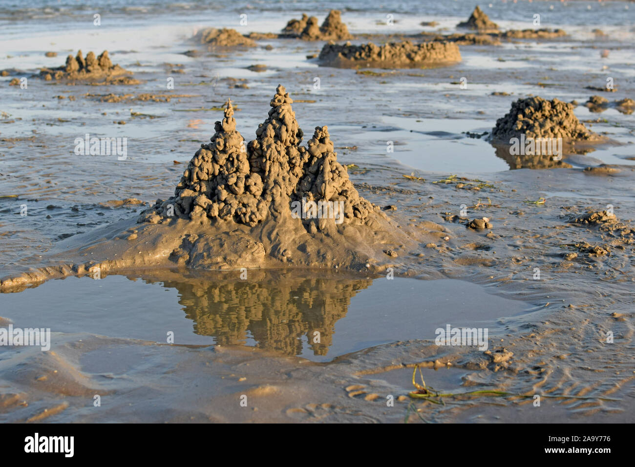 Sand castle on the water. Sand castle on the beach. Children's ...
