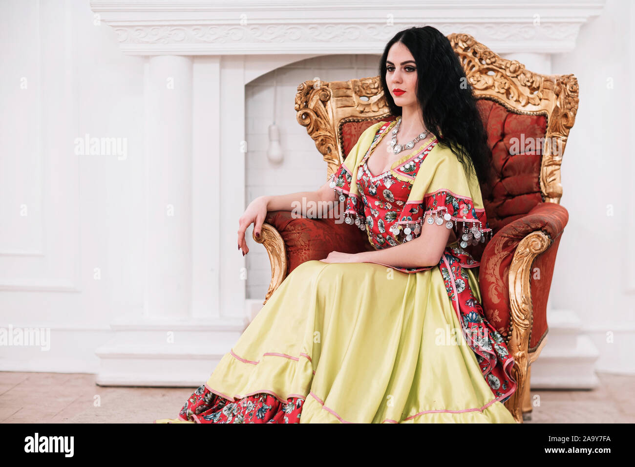 beautiful young Gypsy woman sitting in a chair Stock Photo - Alamy