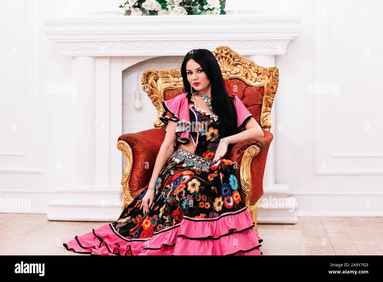 beautiful young Gypsy woman sitting in a chair Stock Photo - Alamy