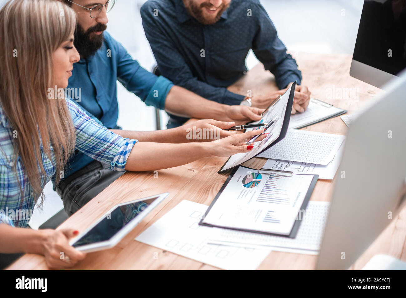 group of designers discussing sketches for a new project Stock Photo ...