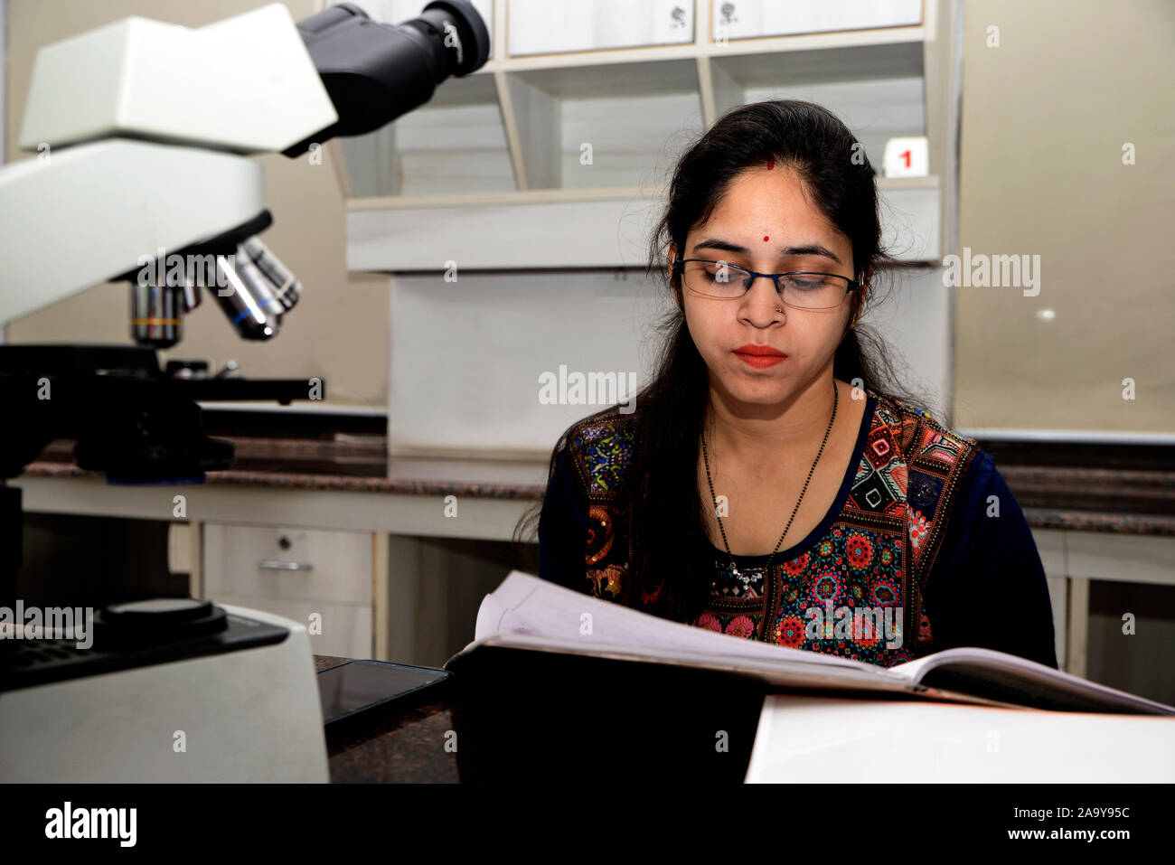 Female Student reading in Laboratory Stock Photo - Alamy