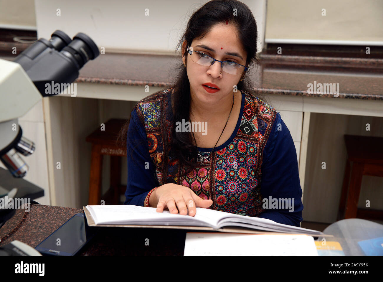 Female Student reading in Laboratory Stock Photo - Alamy