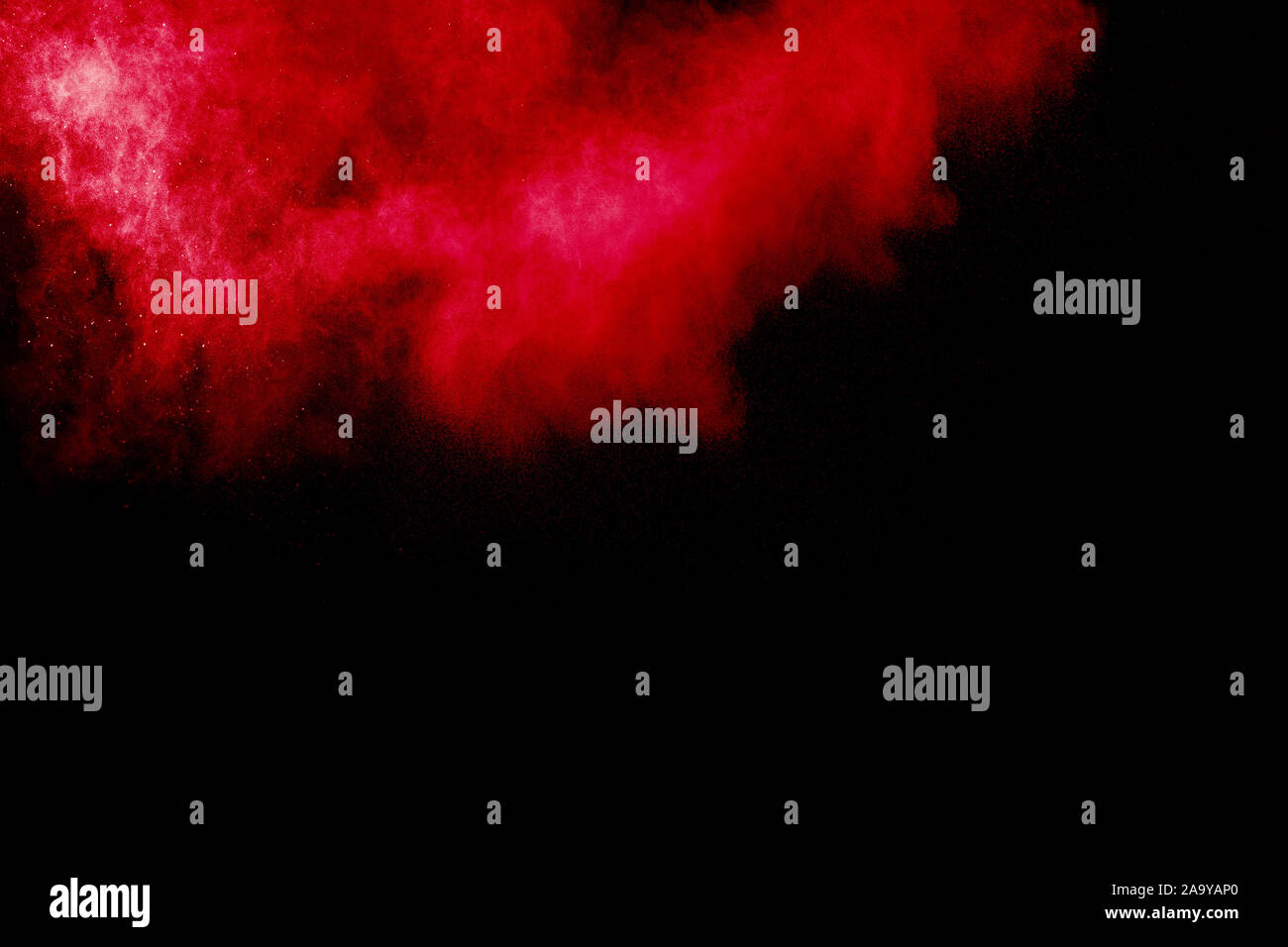 Red color powder explosion on black background.Freeze motion of red ...