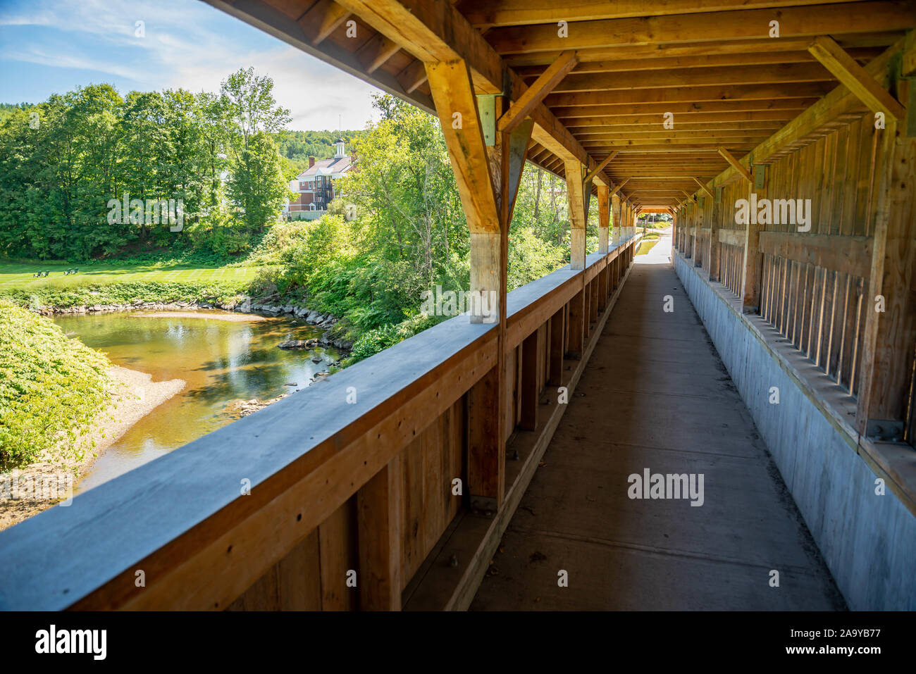 A colorful landcape reflected in the Little River in Stowe, Vermont ...