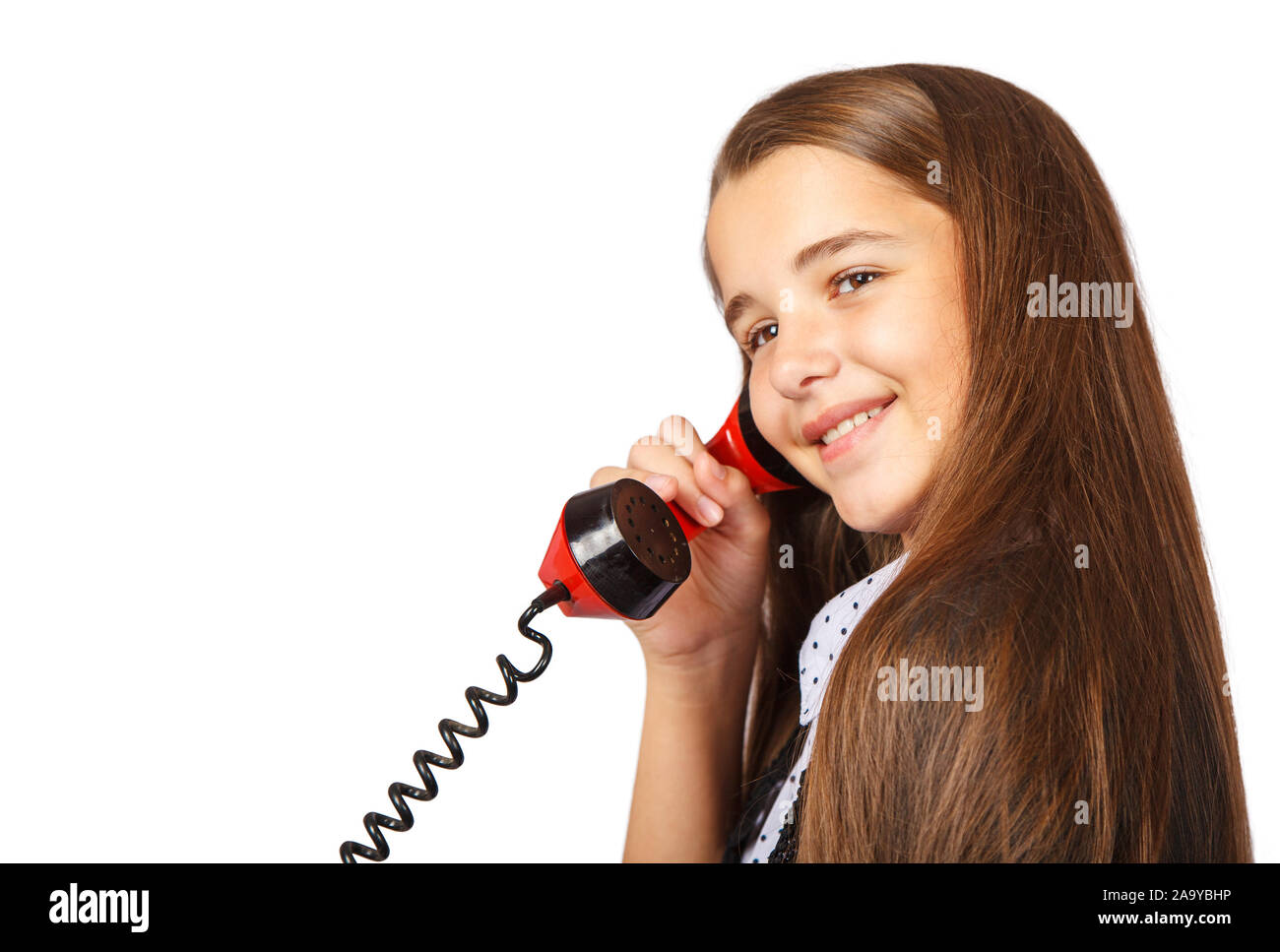 teenage girl talking on red retro telephone closeup on white background ...