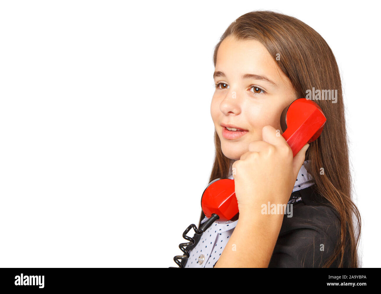 teenage girl talking on red retro telephone closeup on white background ...