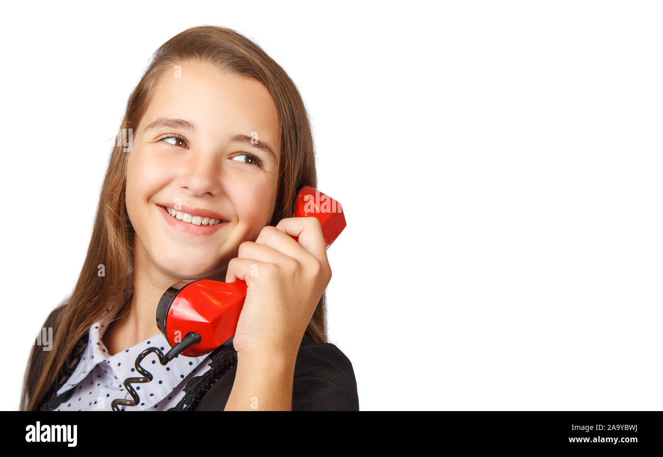 teenage girl talking on red retro telephone closeup on white background ...