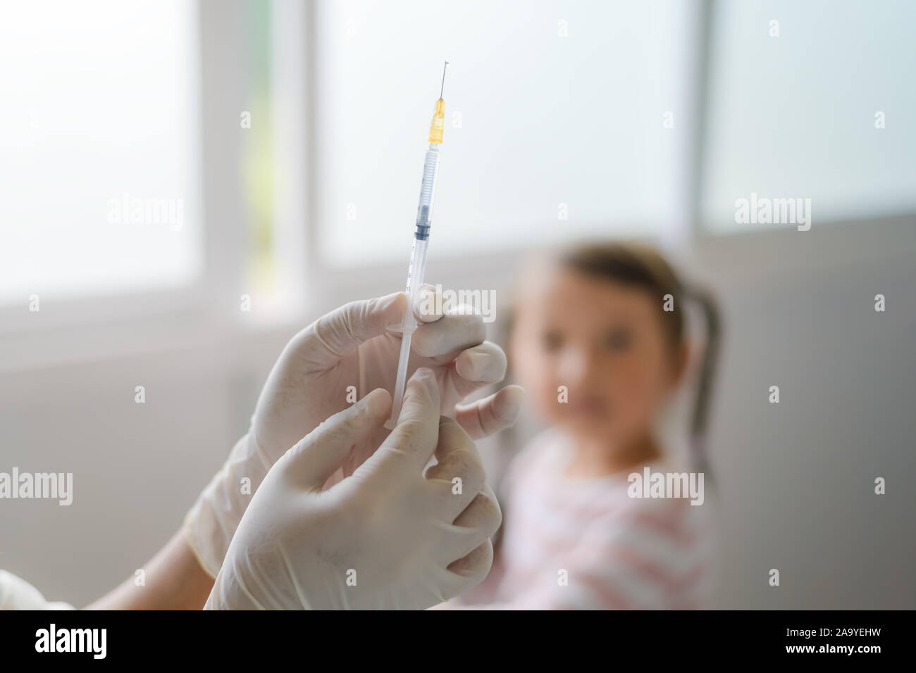 Doctor hand with medical syringe in hand ready for injection to Little ...