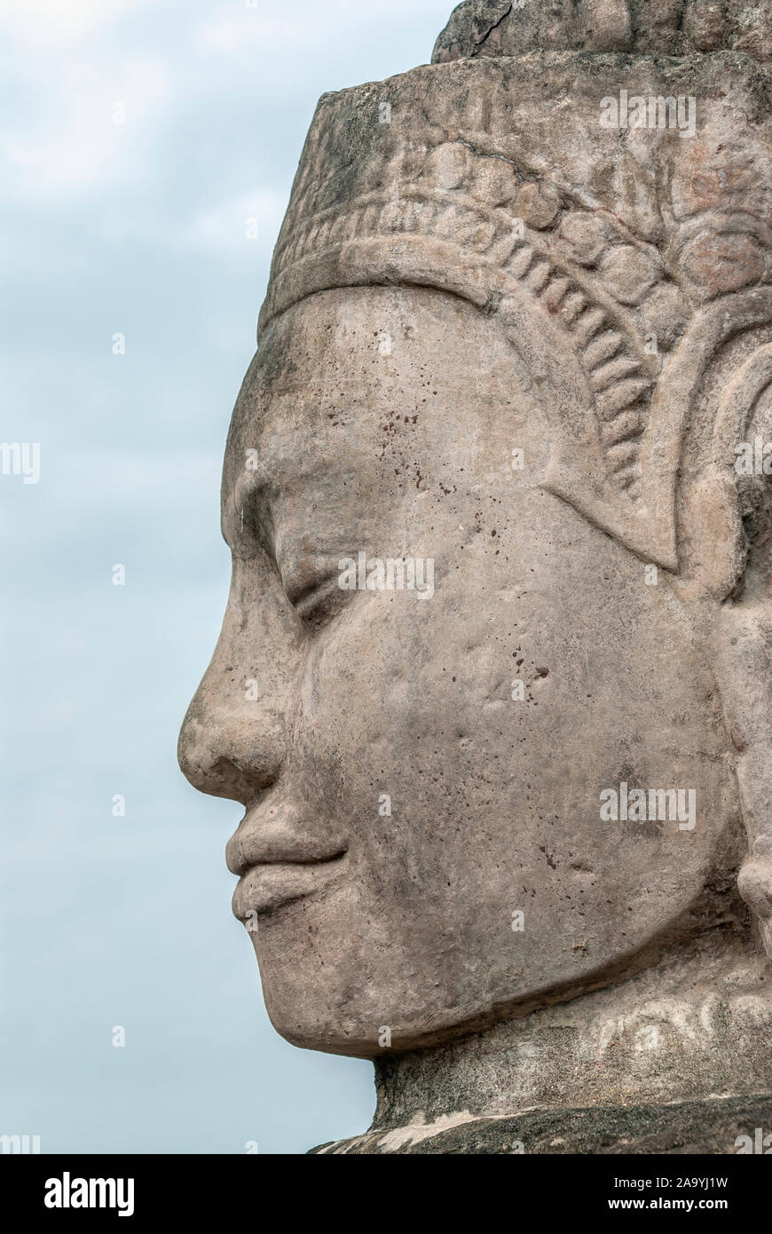 Close up of the face of a temple stone sculpture at the famous Angkor ...
