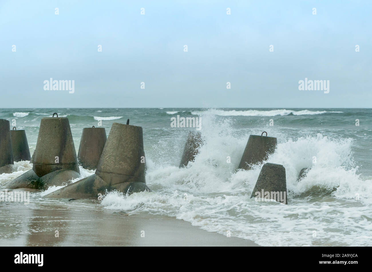 sea waves beat against breakwaters, storm and shore fortifications made ...