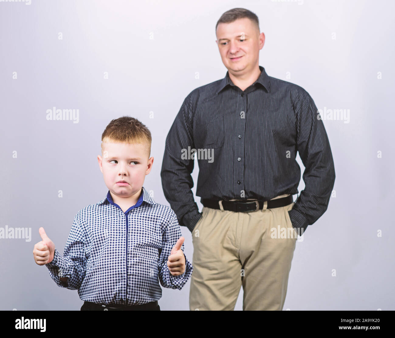 cool and serious. father and son in business suit. male fashion. happy ...