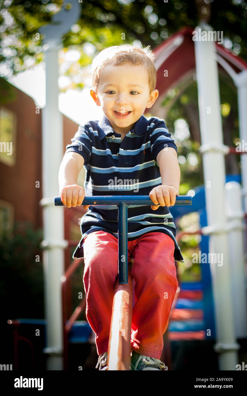 Happy smiling kid playing in the park playground Stock Photo - Alamy