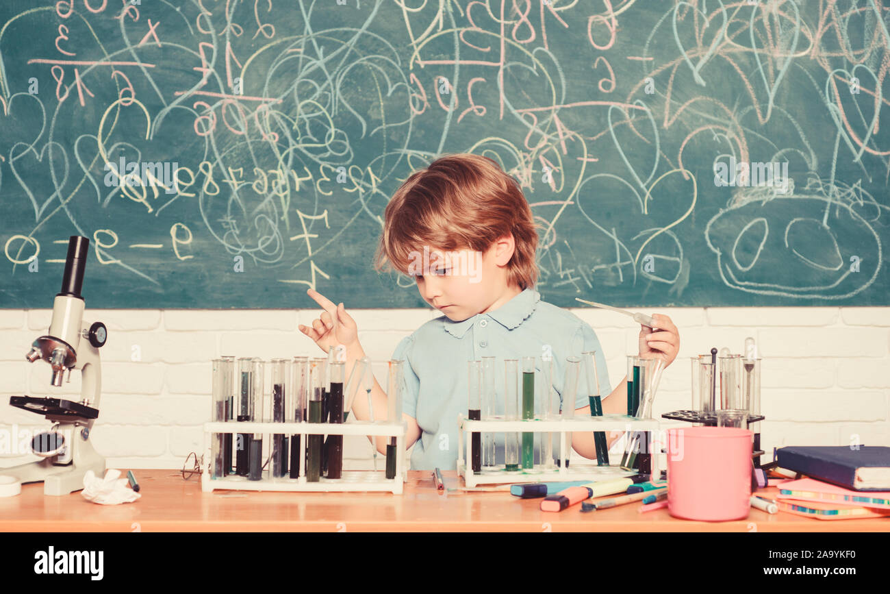 Small pupil learning chemistry in school. Chemistry laboratory ...