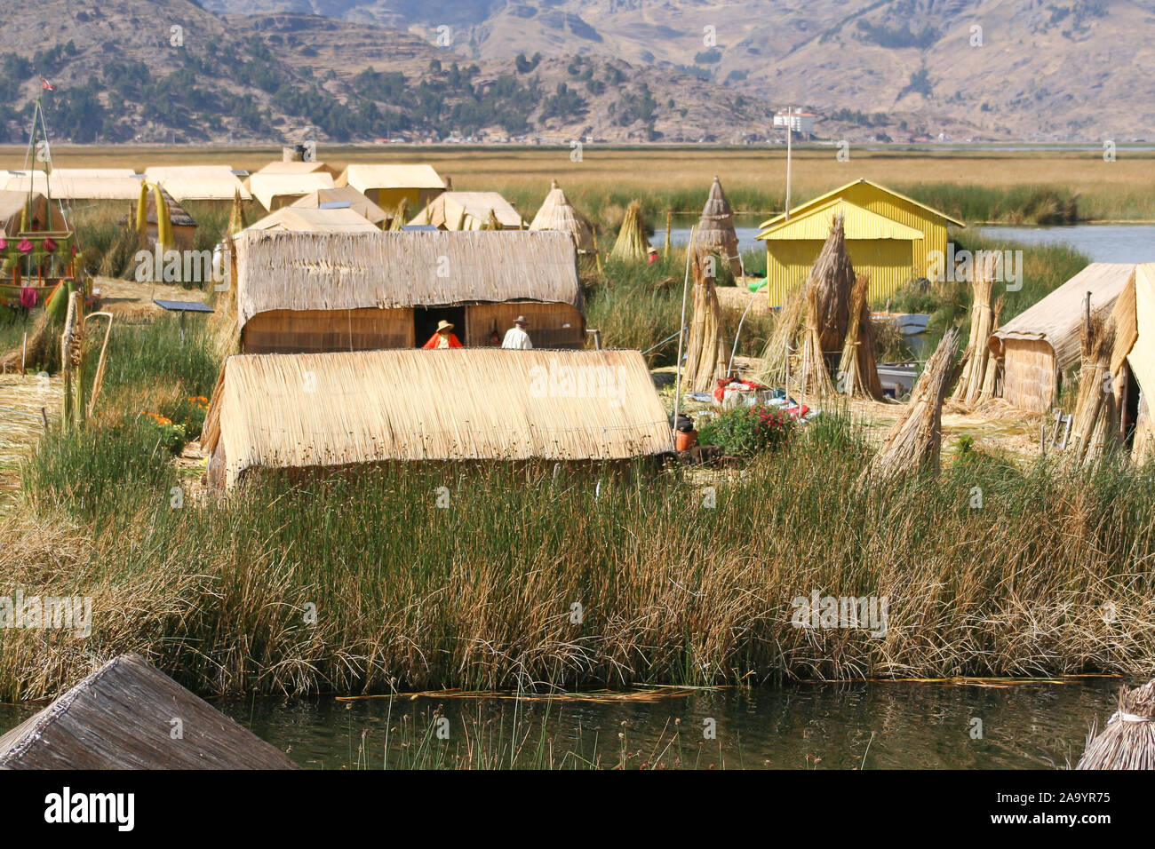 Uros indian woman in traditional reed boat hi-res stock photography and ...