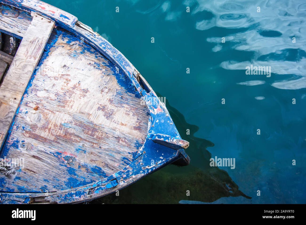 The nose is an old fishing boat with chipping paint at the pier Stock ...