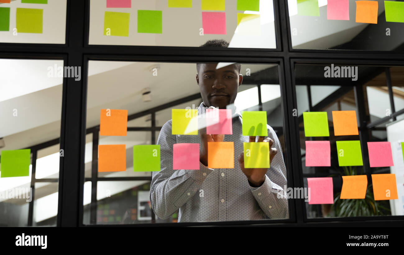 Focused millennial african american male manager organizing working ...