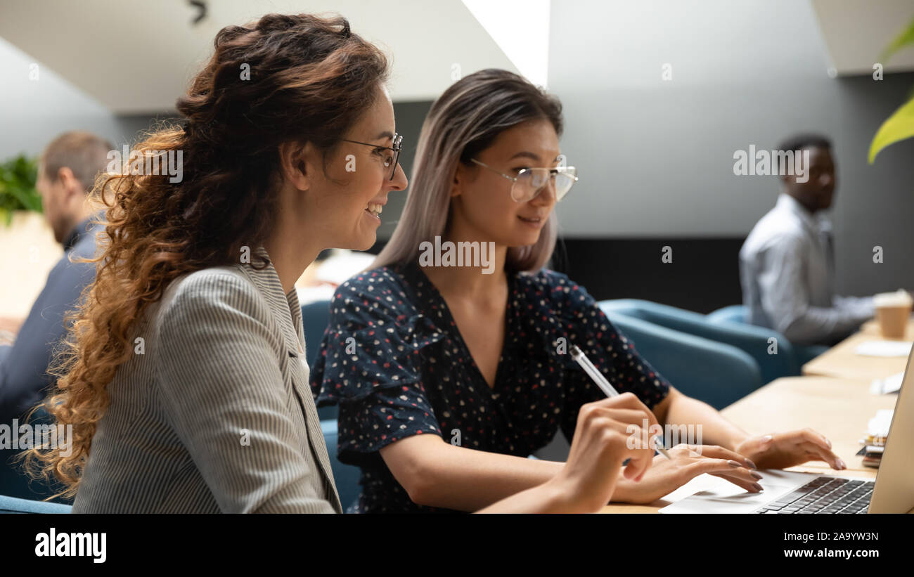 Asian coach mentoring millennial newbie intern in office Stock Photo ...