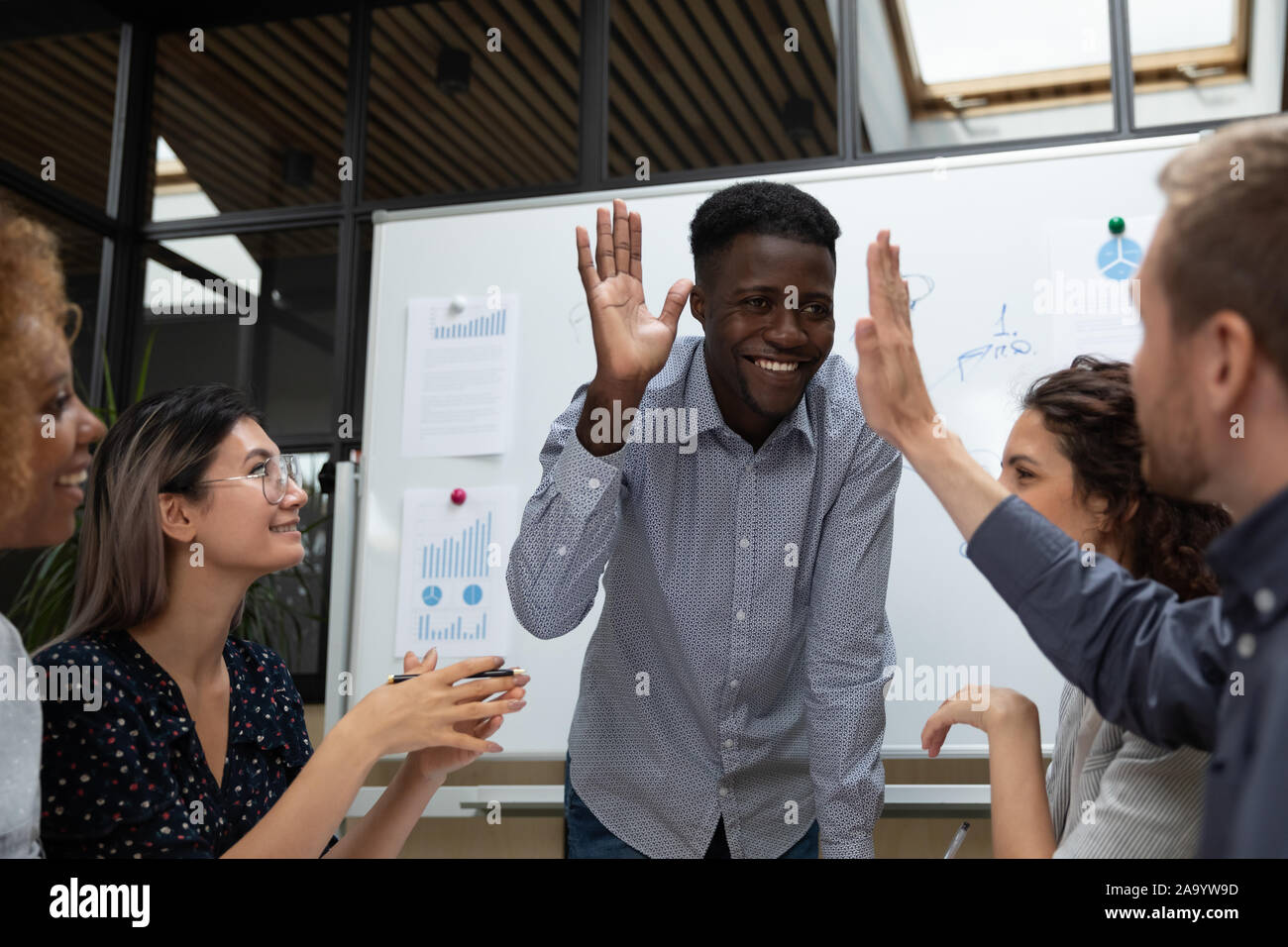 Happy african american team leader giving high five to partner Stock ...