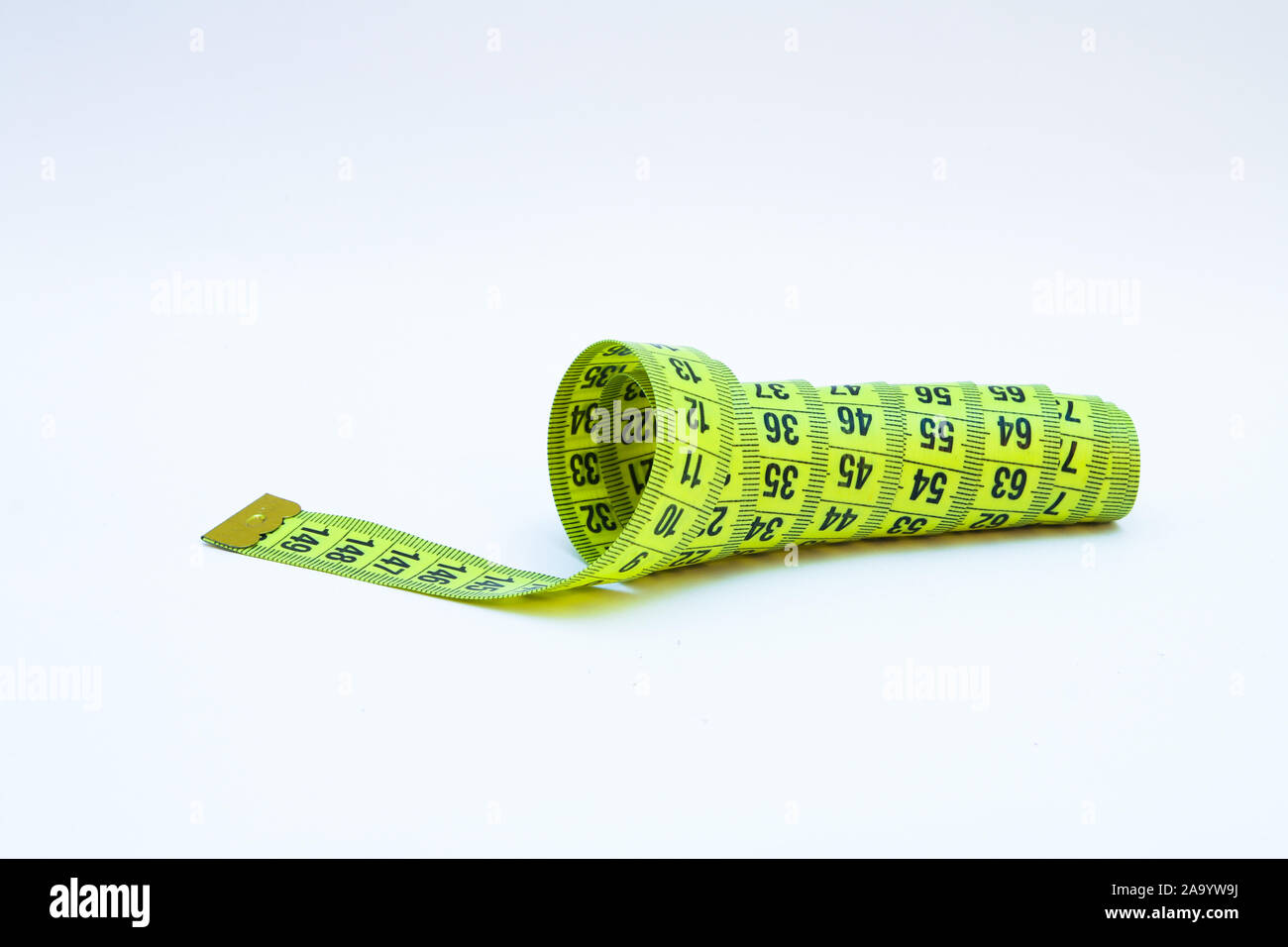 Yellow tape measure in meters and inches in a spiral Stock Photo - Alamy
