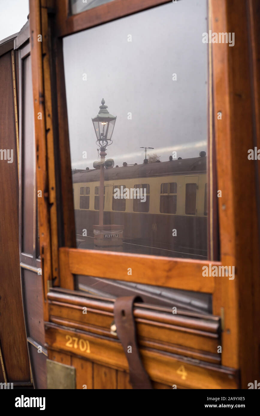 Reflection of old-fashioned gas lamp & vintage train in window of 3rd ...
