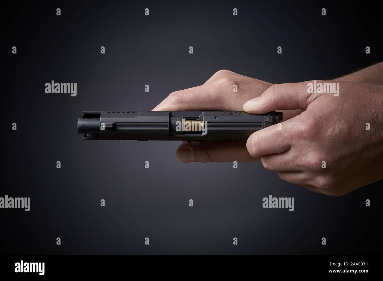 reloading a handgun, pulling back slide, top view Stock Photo - Alamy