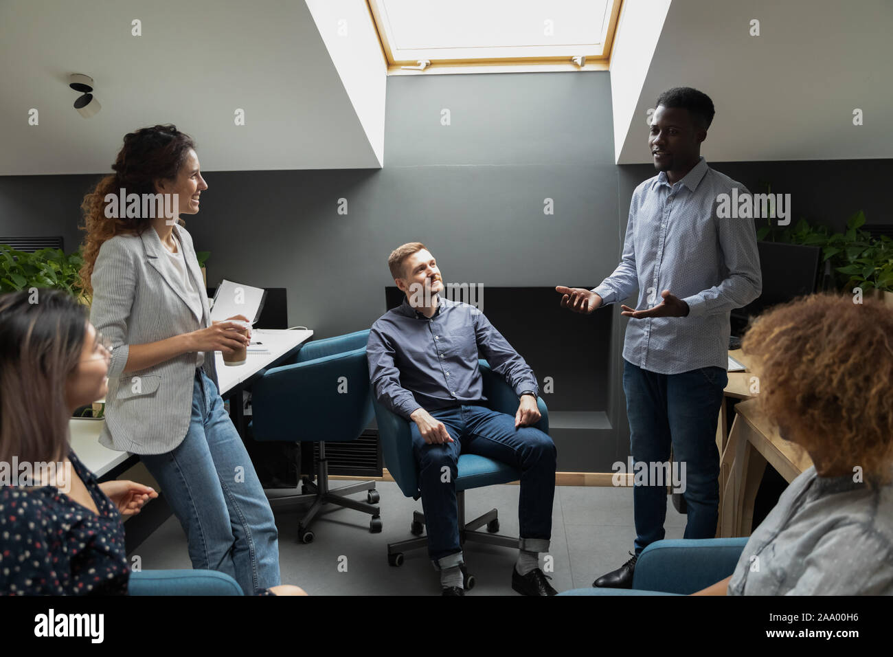 Interested multiracial group of employees listening to african american ...