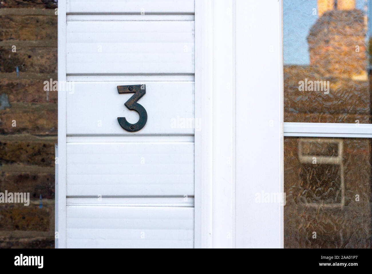 House number 3 on a white wooden wall made out of boards Stock Photo ...