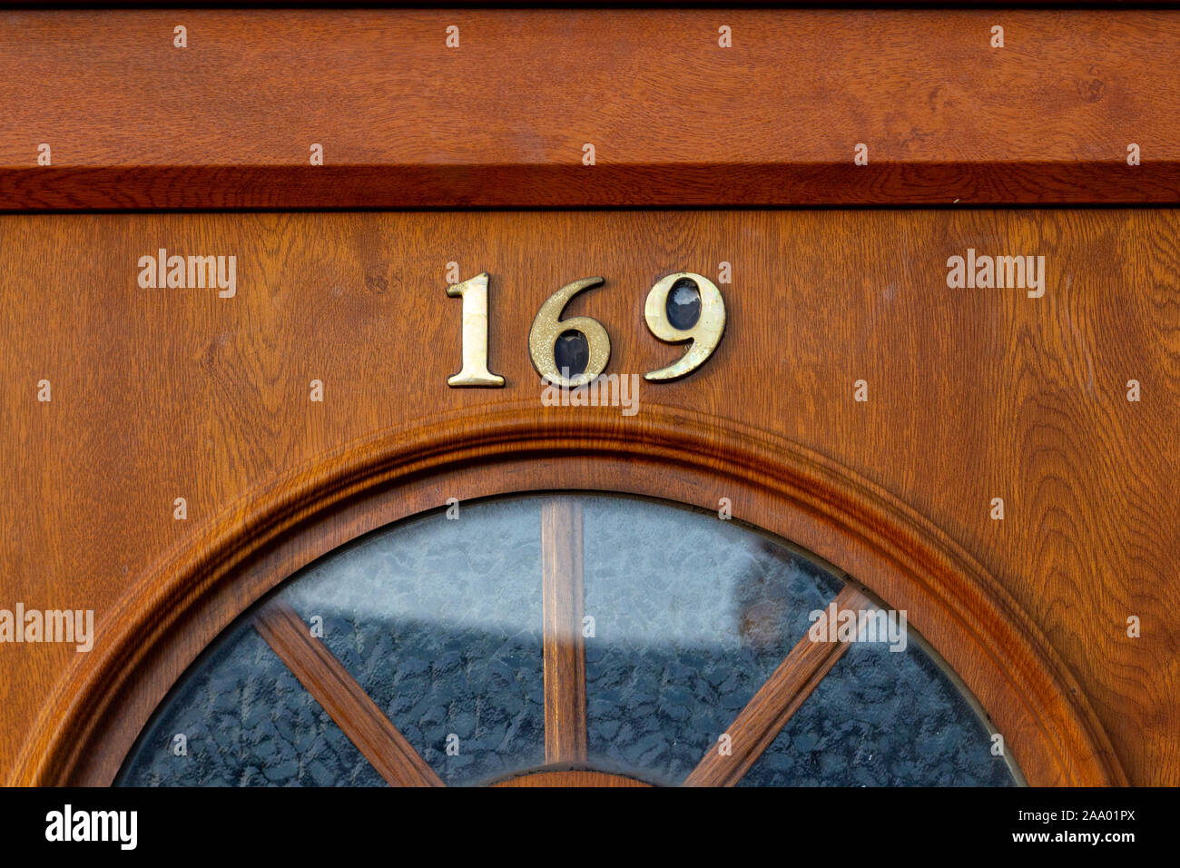 House number 169 on a wooden front door with glass panels Stock Photo ...