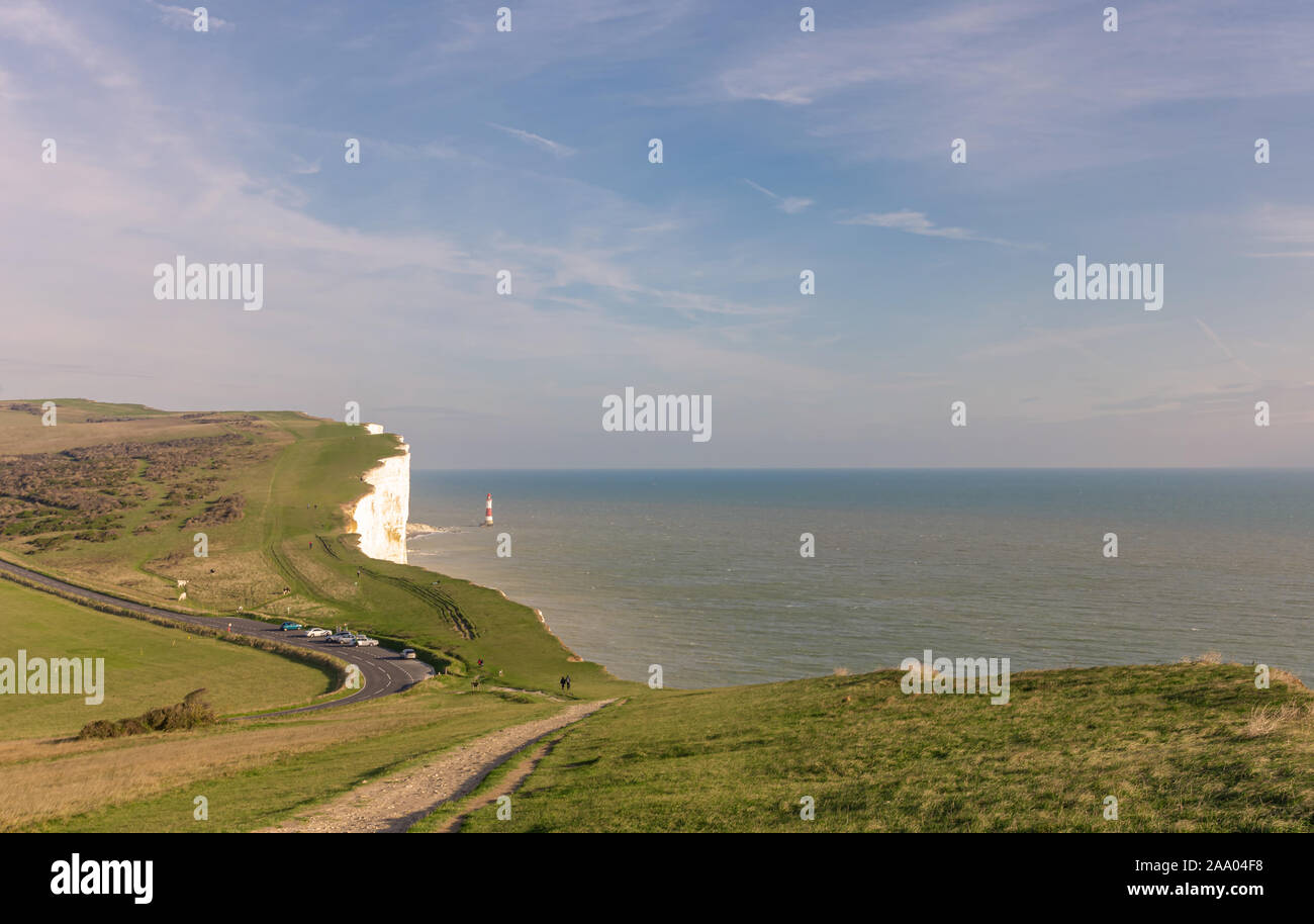 A panorama of the chalk cliffs of Beachy Head with a lighthouse just ...