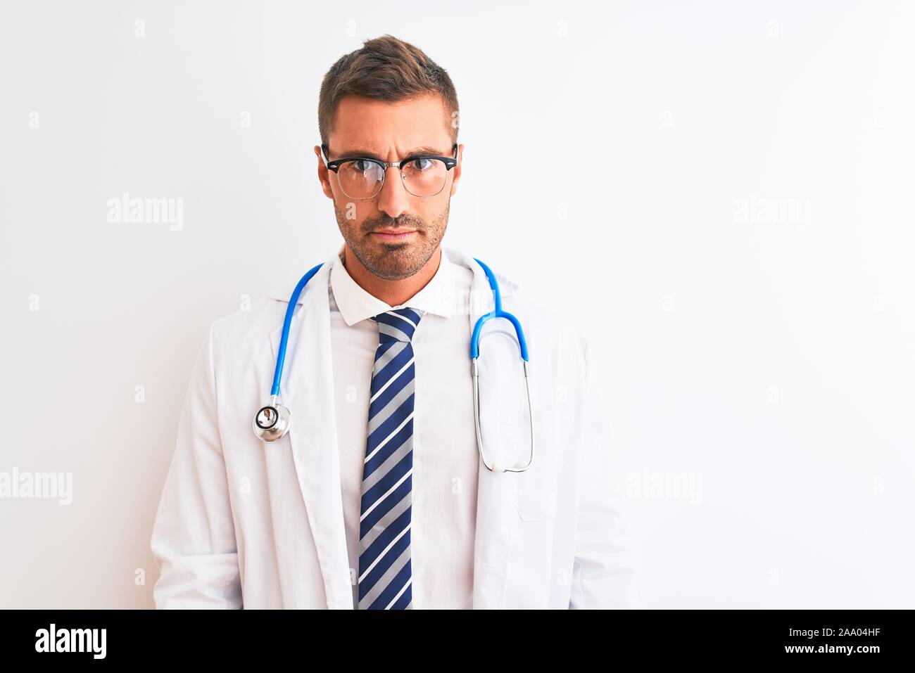 Young handsome doctor man wearing stethoscope over isolated background ...