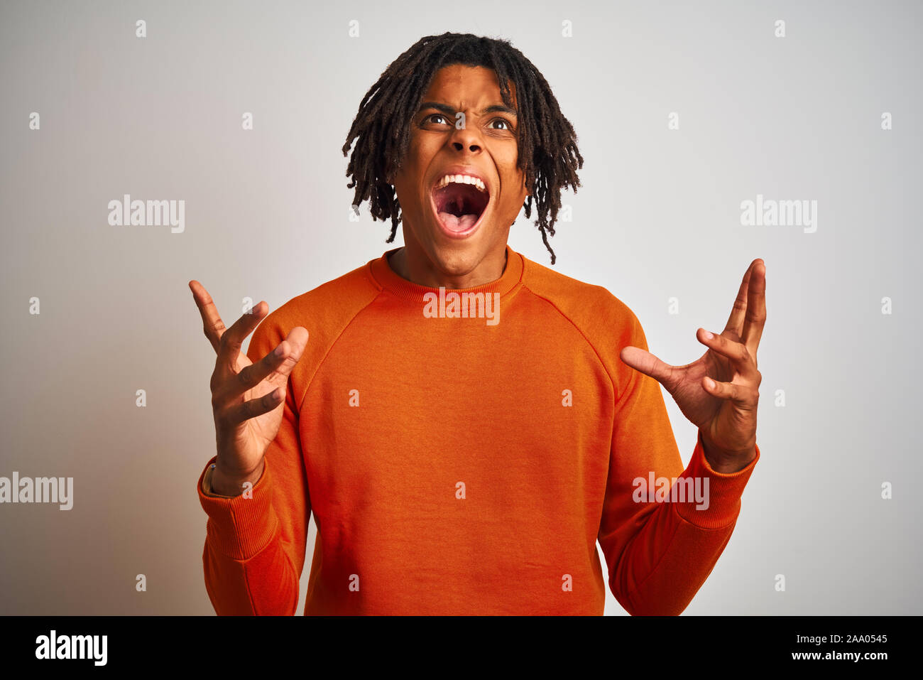 Afro american man with dreadlocks wearing orange sweater over isolated ...