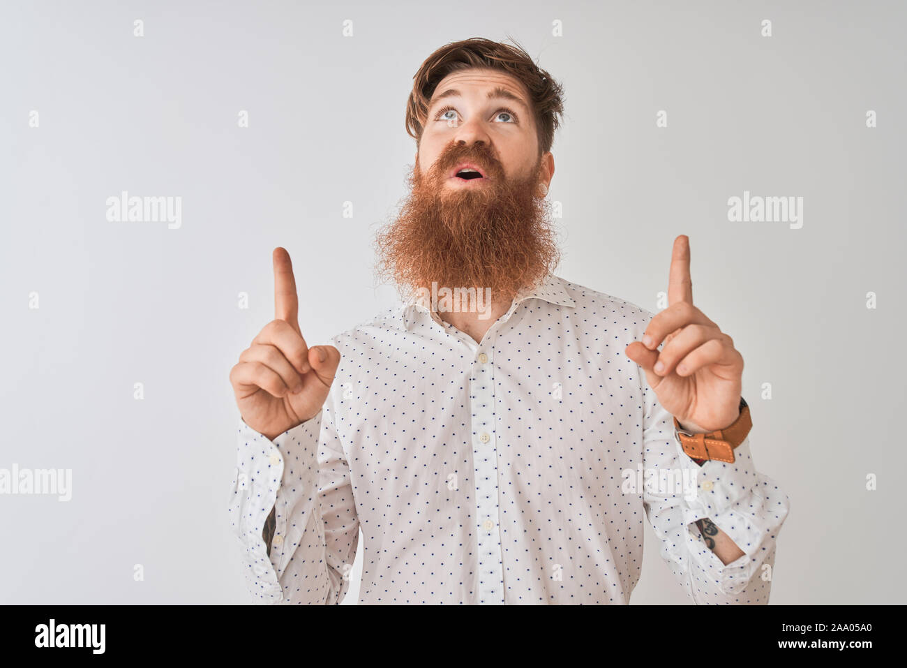 Young redhead irish man wearing shirt standing over isolated white ...