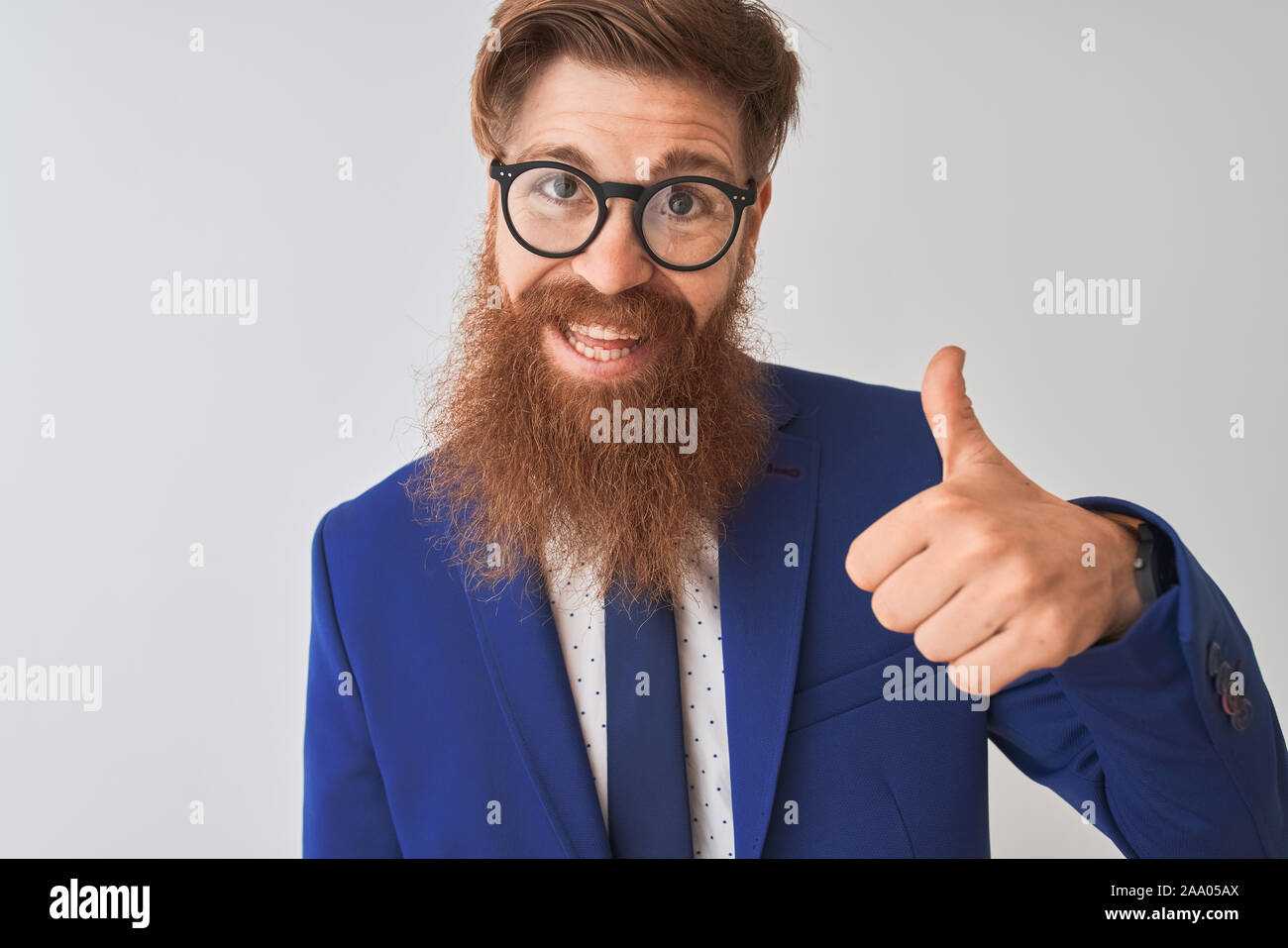 Young redhead irish businessman wearing suit and glasses over isolated ...