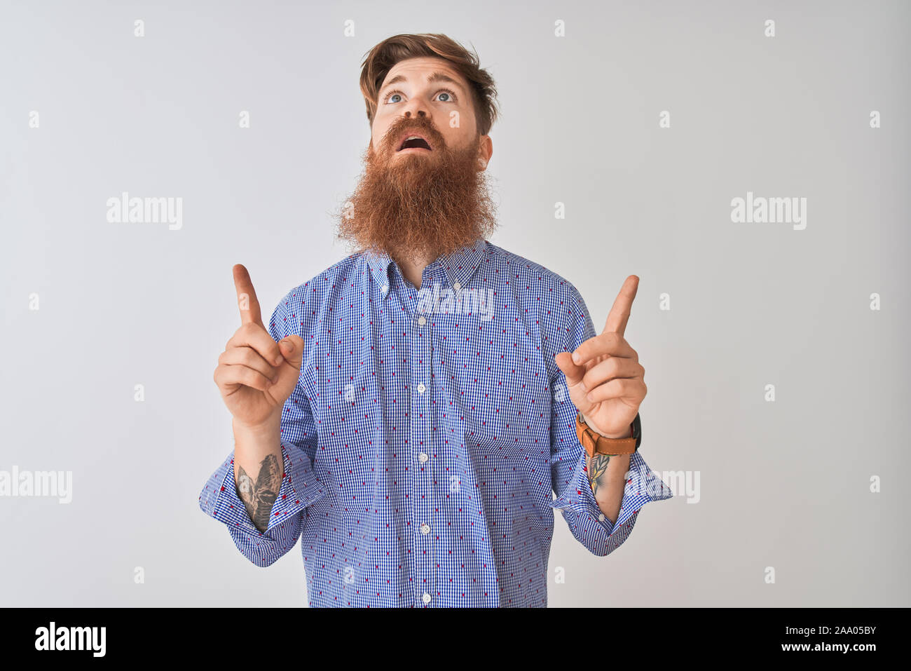 Young redhead irish man wearing casual shirt standing over isolated ...