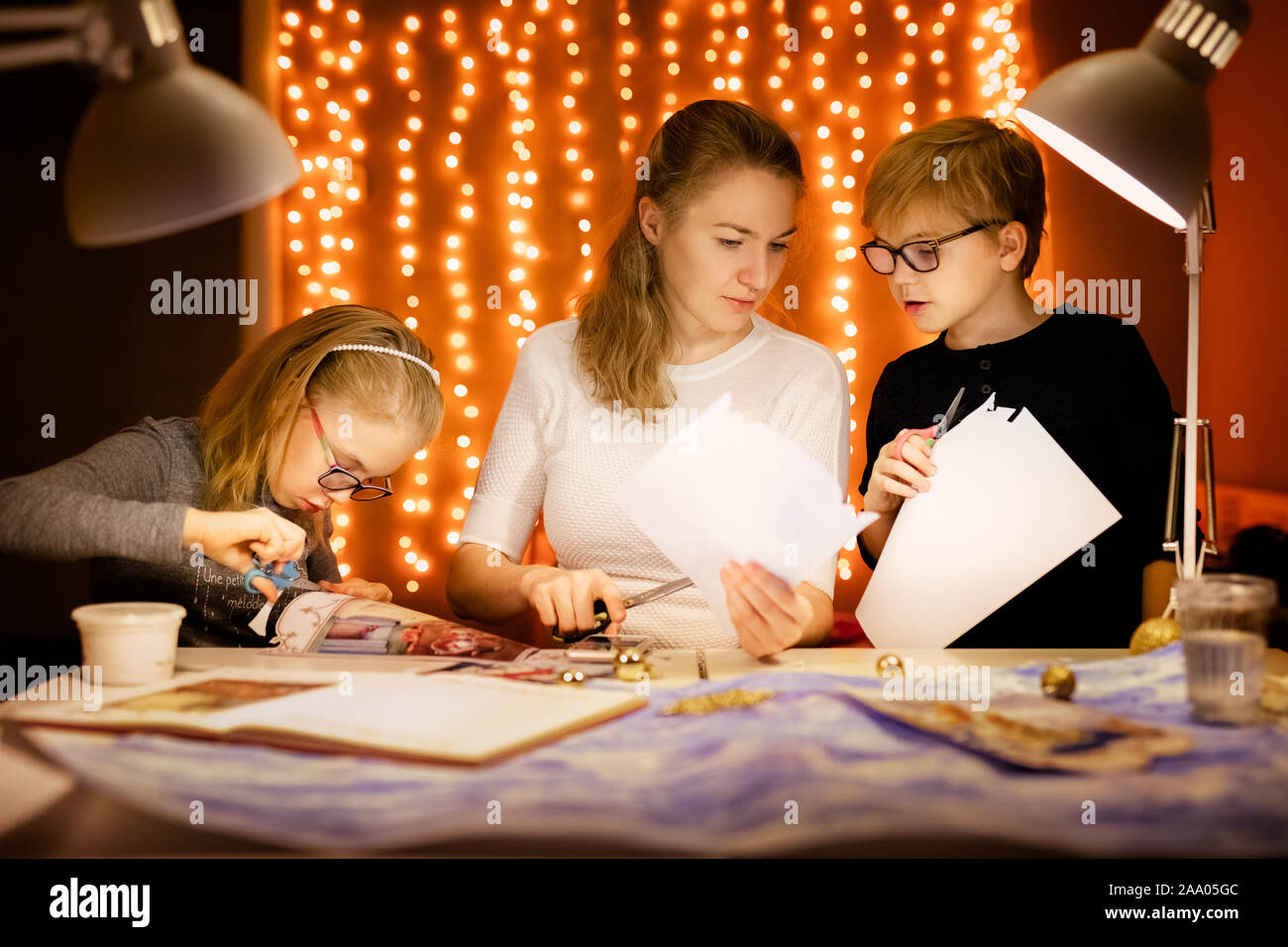 Little blonde bou and girl and their mother writes the letter to Santa ...