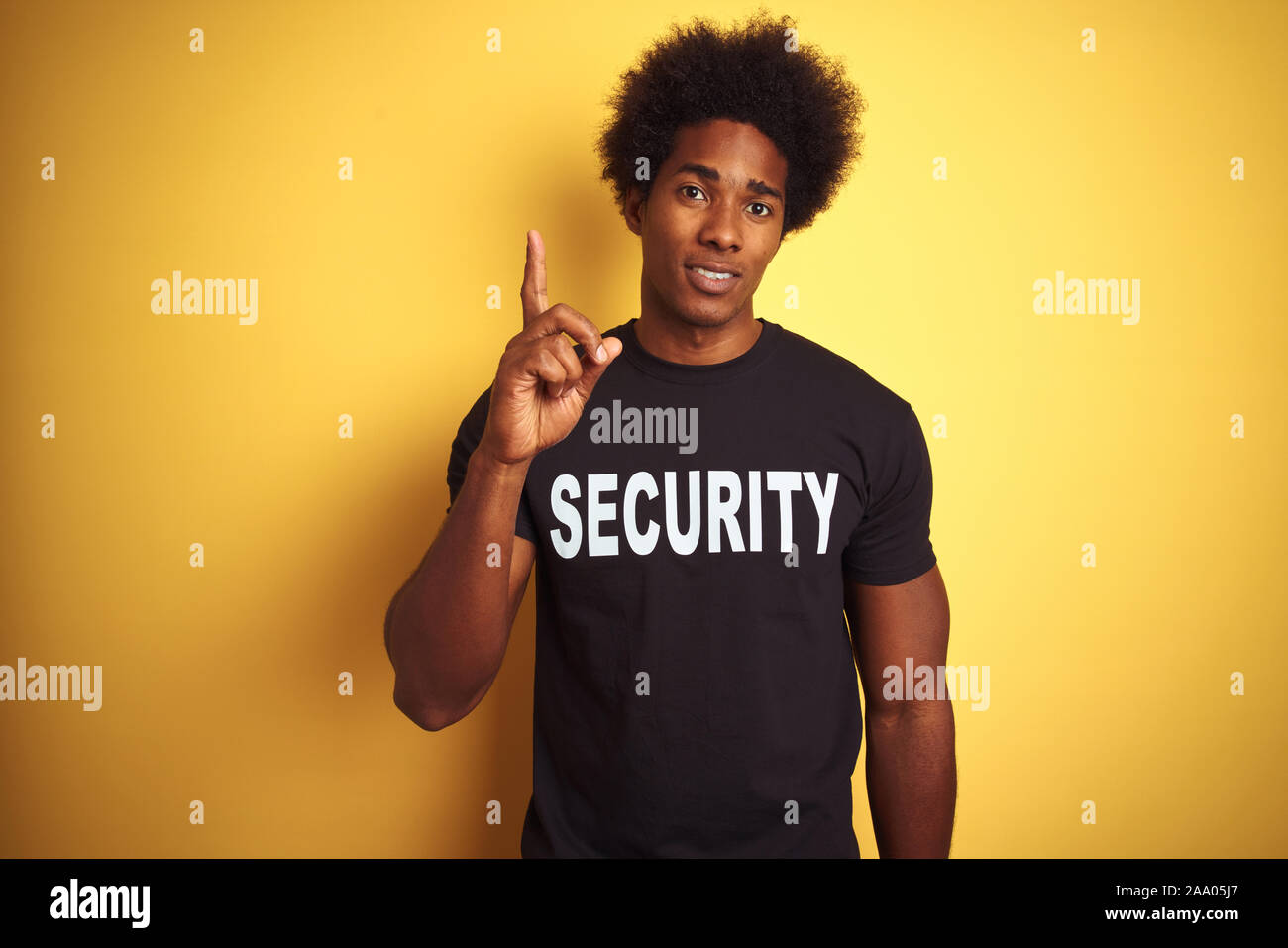American safeguard man with afro hair wearing security uniform over ...