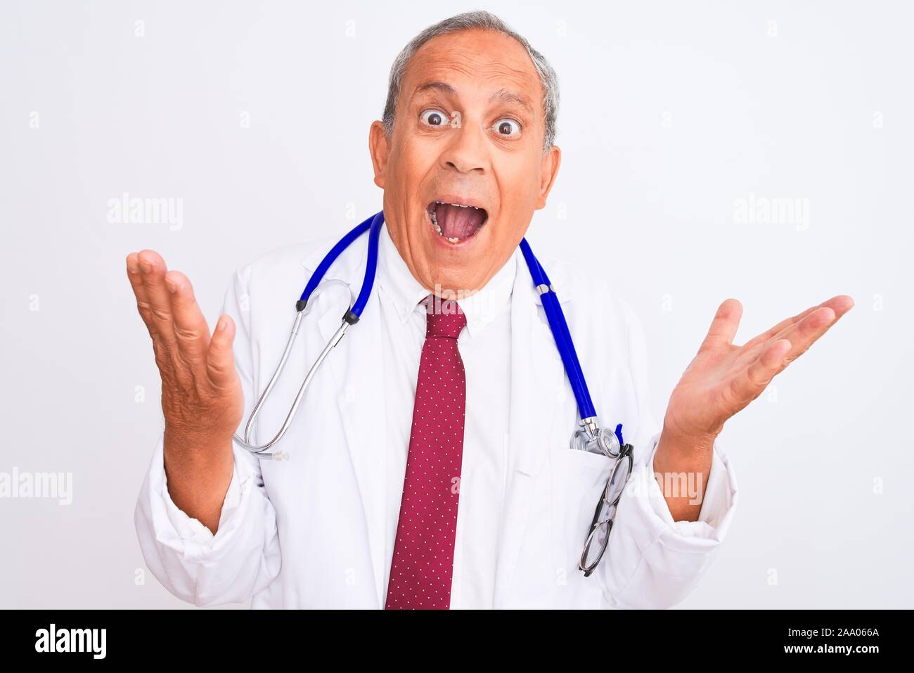 Senior grey-haired doctor man wearing stethoscope standing over ...