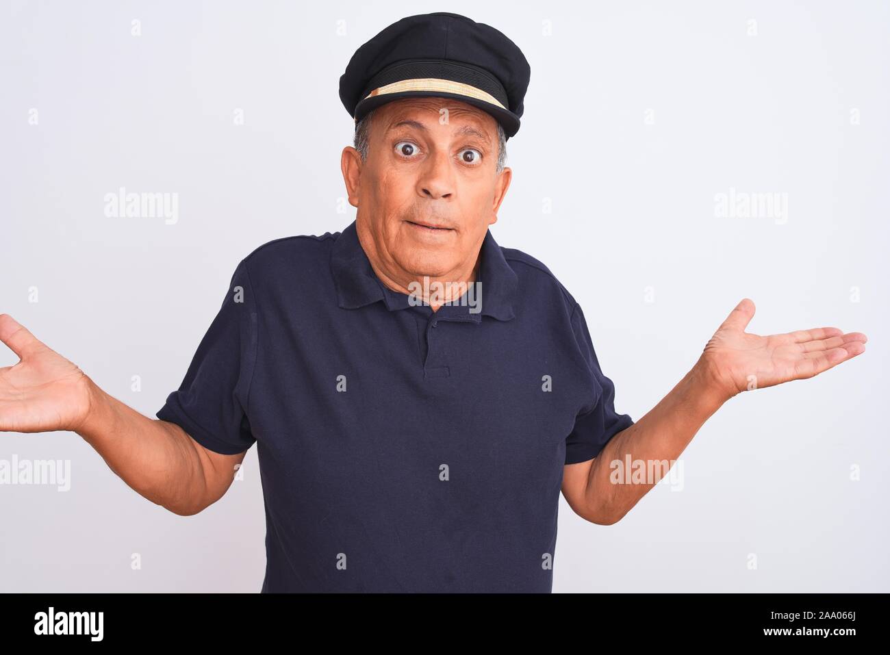 Senior grey-haired man wearing black polo and captain hat over isolated ...