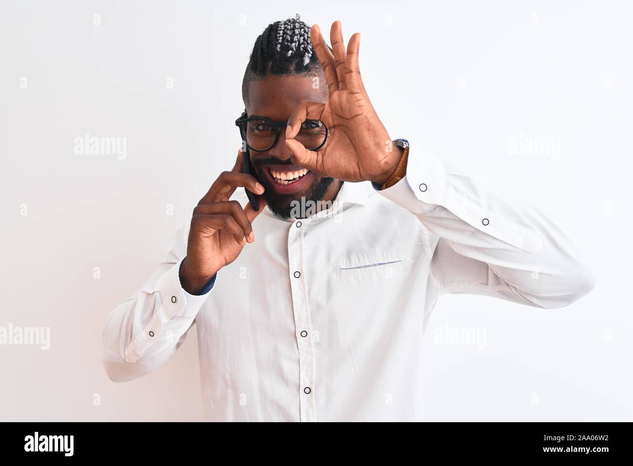 African american businessman talking on smartphone over isolated white ...