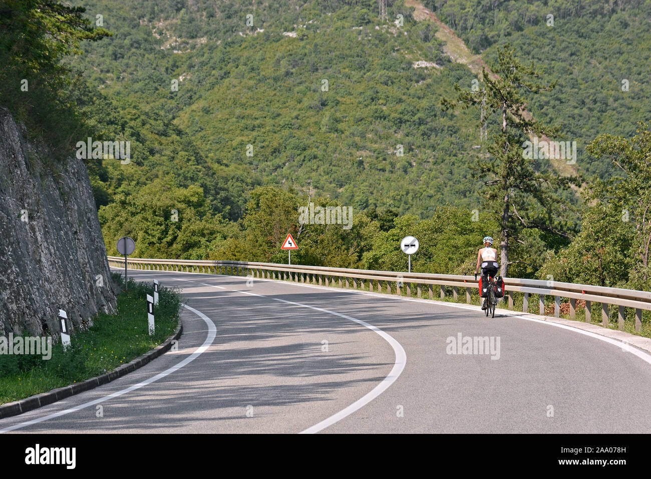 Steep turn of an asphalt road in the mountains of Croatia with a ...