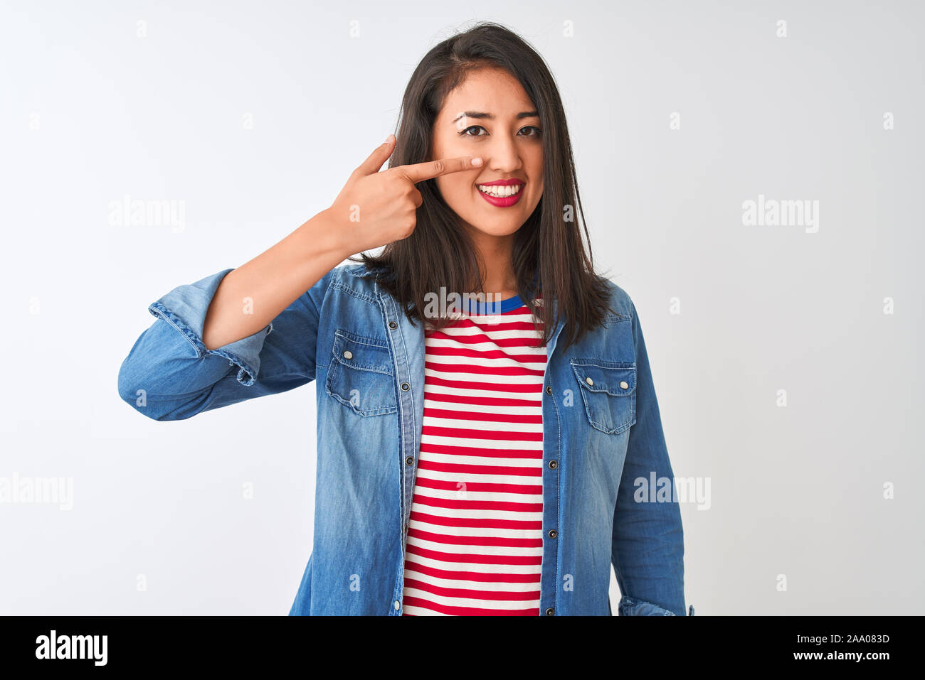 Young chinese woman wearing striped t-shirt and denim shirt over ...