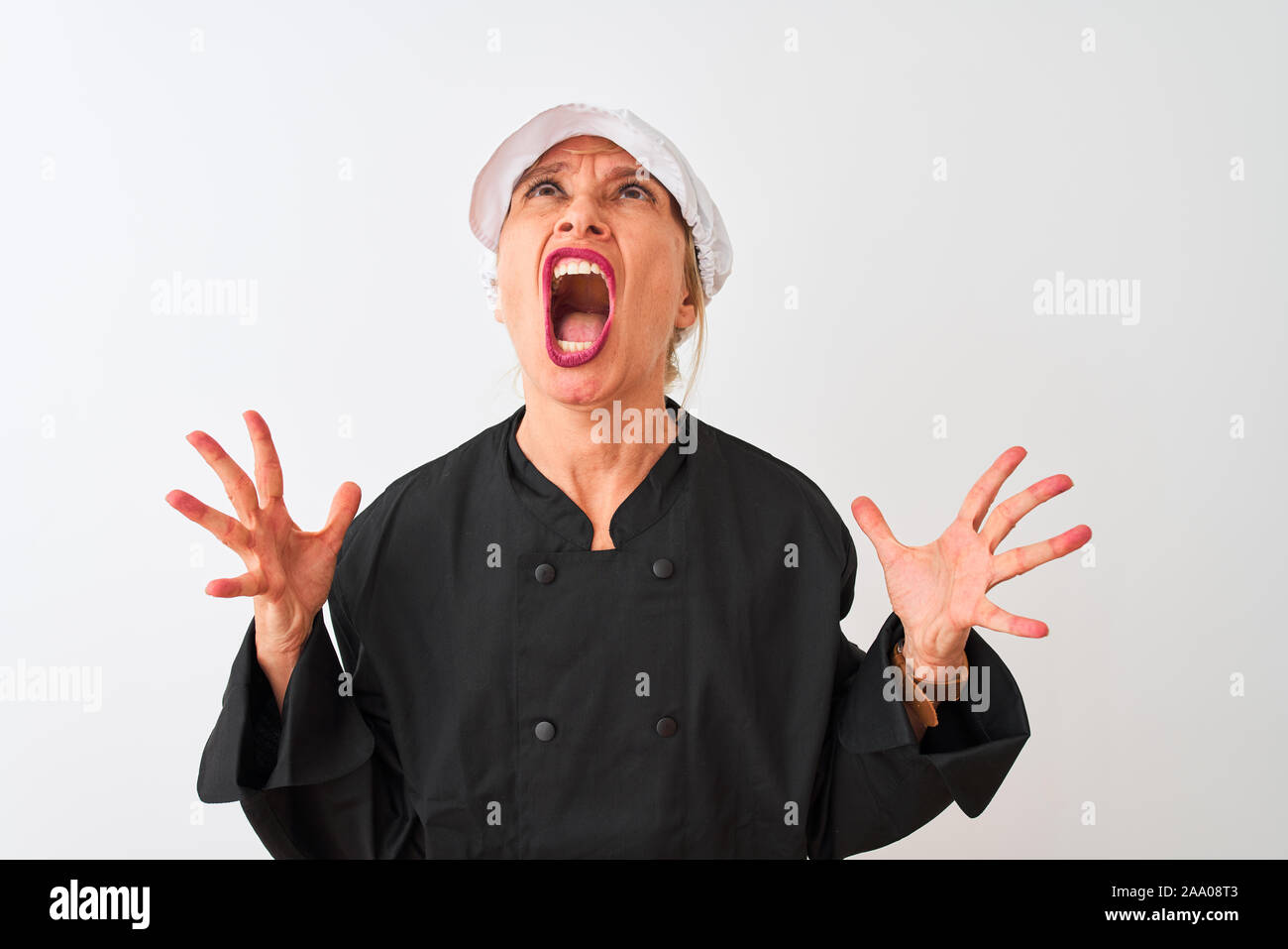 Middle age chef woman wearing uniform and cap standing over isolated ...