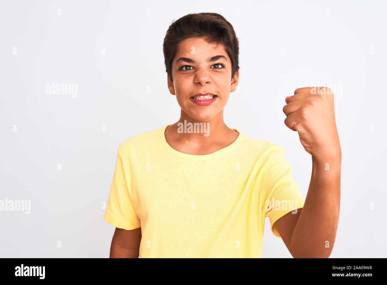Handsome teenager boy standing over white isolated background angry and ...