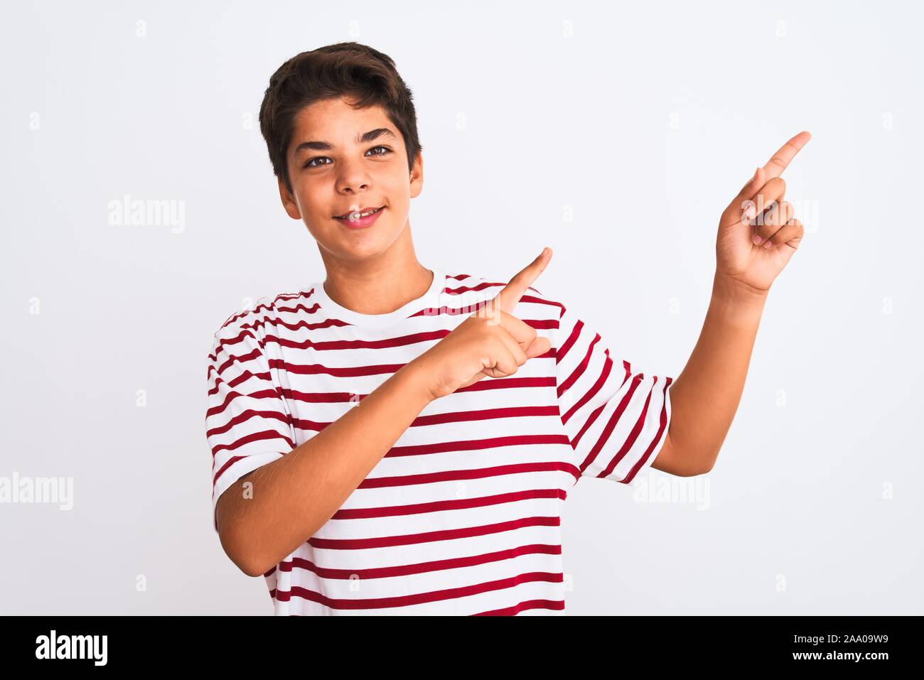 Handsome teenager boy standing over white isolated background smiling ...