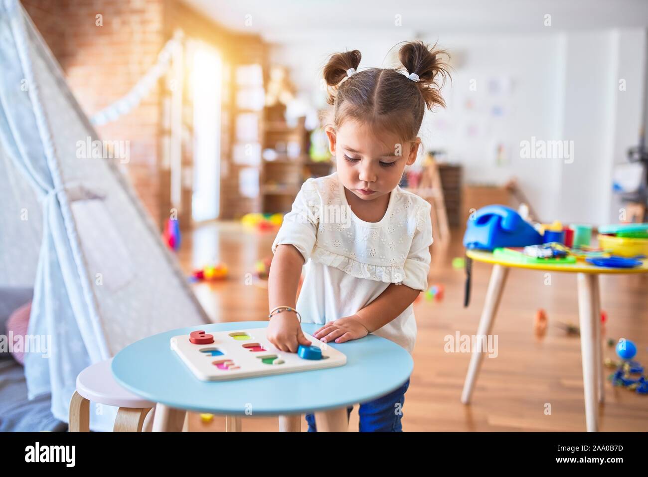 Young beautiful toddler learning mathematics playing with maths game at ...