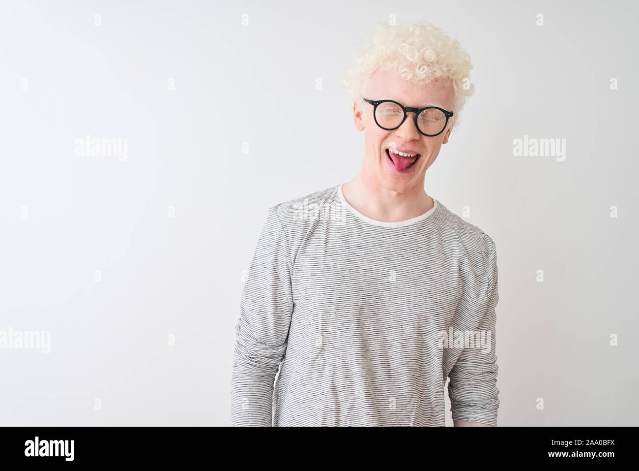 Young albino blond man wearing striped t-shirt and glasses over ...